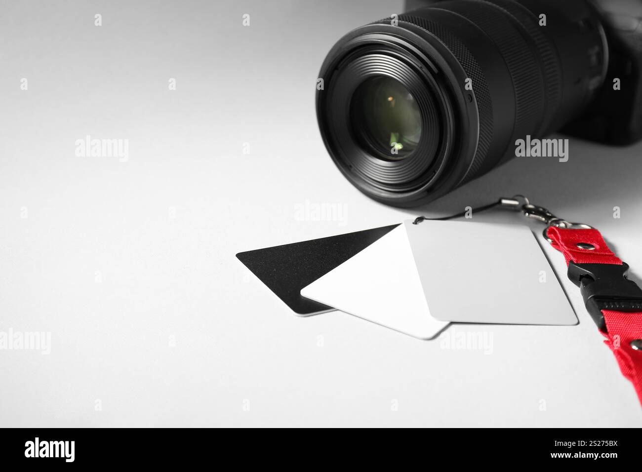 White balance calibration cards and camera on light background, closeup ...