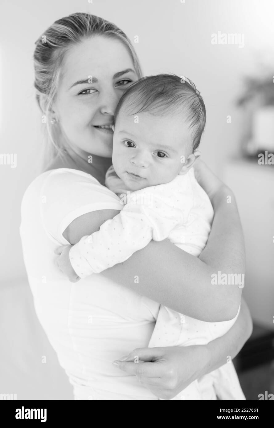 Black and white image of cheerful young mother hugging her baby boy Stock Photo - Alamy