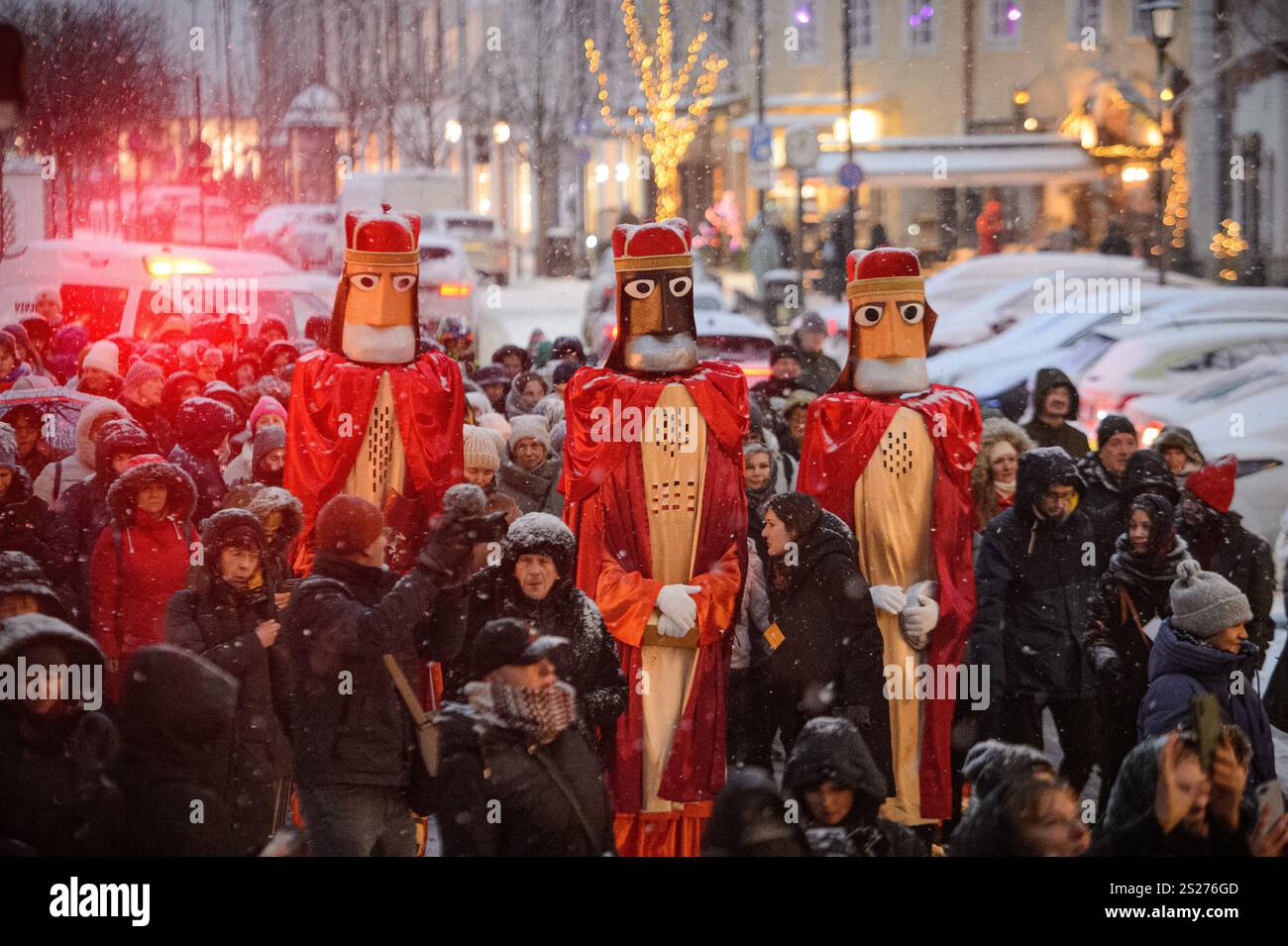 Actors dressed as the Three Kings walk through the streets of Vilnius ...