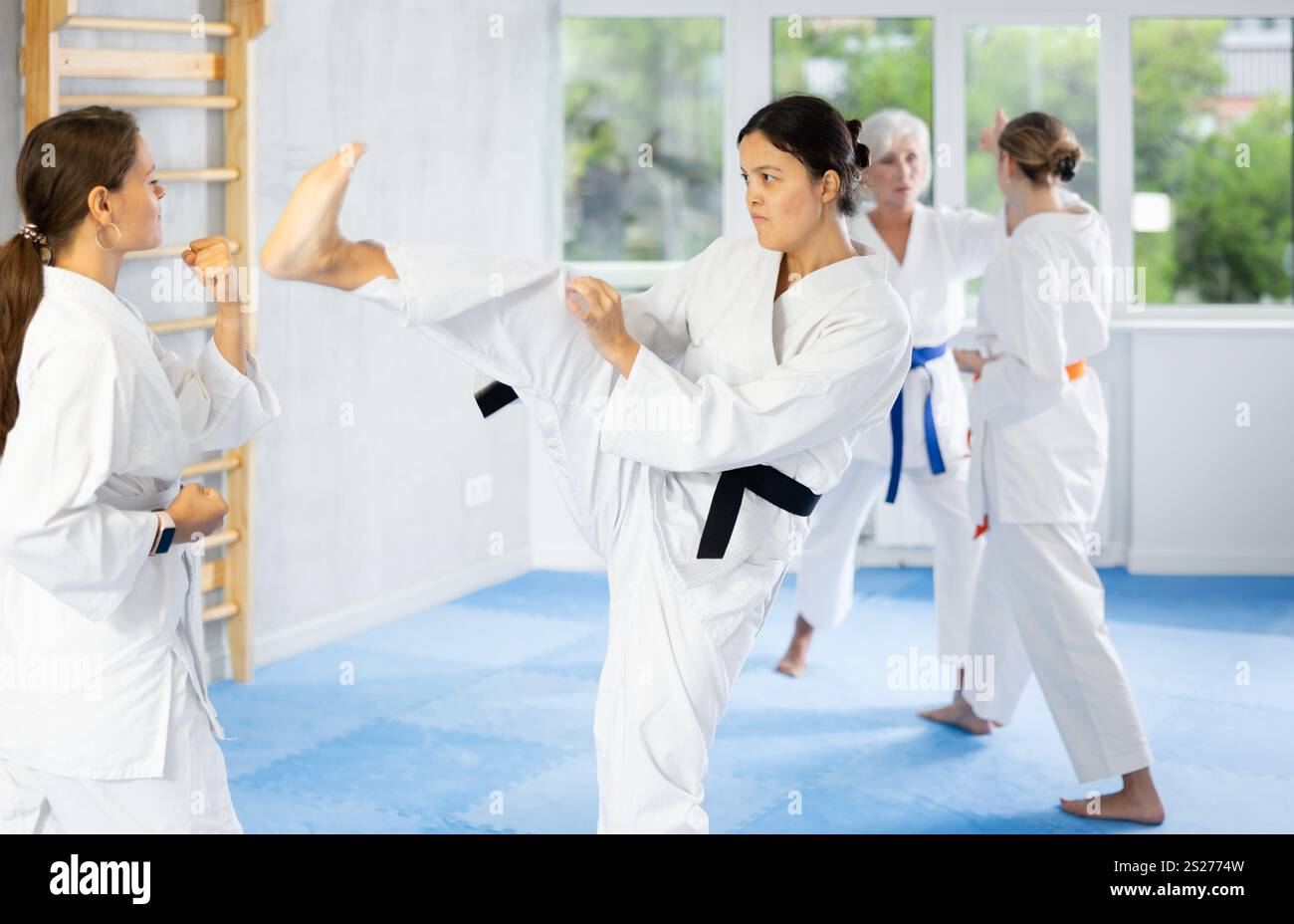 Asian female karateka honing kicking techniques during kumite Stock ...