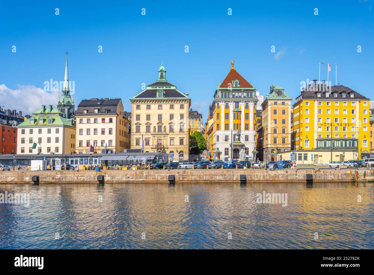 Vibrant buildings in Stockholm's old town reflect in the calm water ...