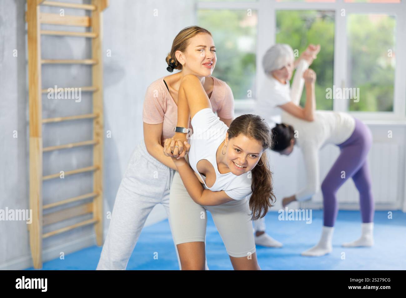 Self-defense class - woman learns to fight back an attacking man under ...