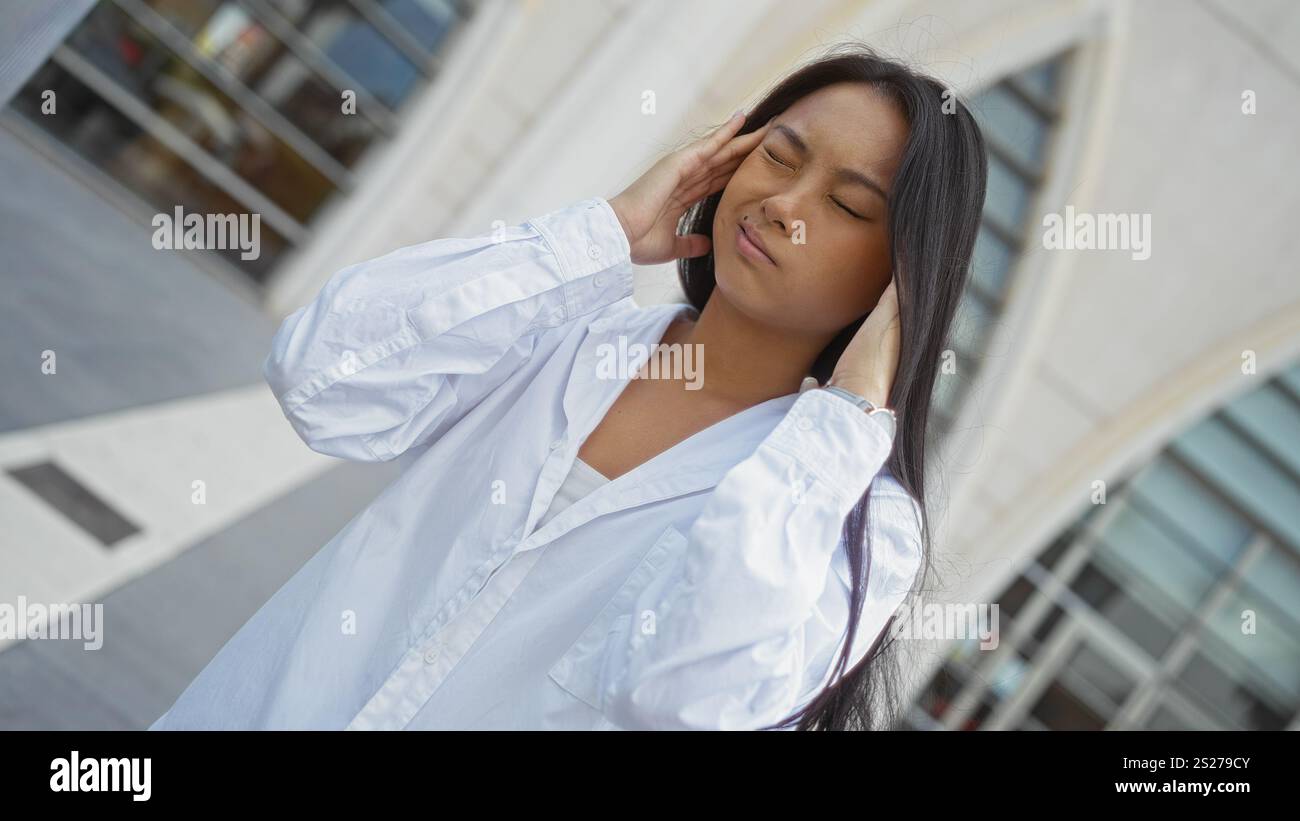 Young chinese woman feeling stressed on an urban street in china Stock ...