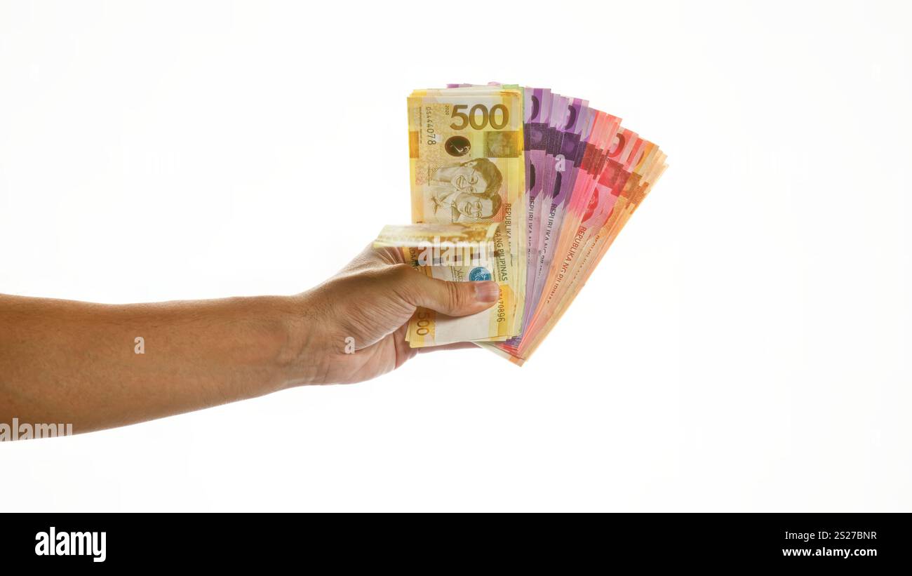 Hand holding philippine peso bills over an isolated white background ...