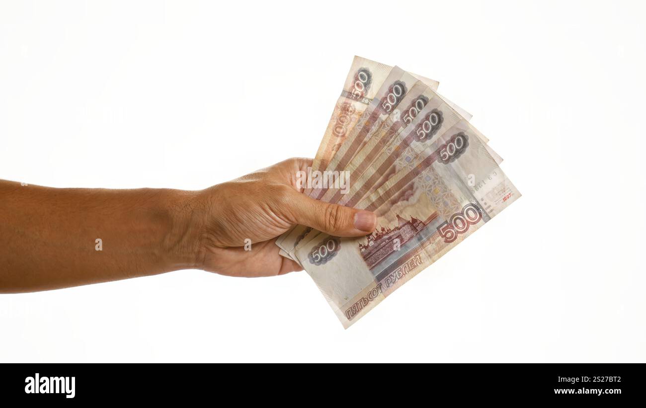 Hand holding several russian rubles on an isolated white background ...