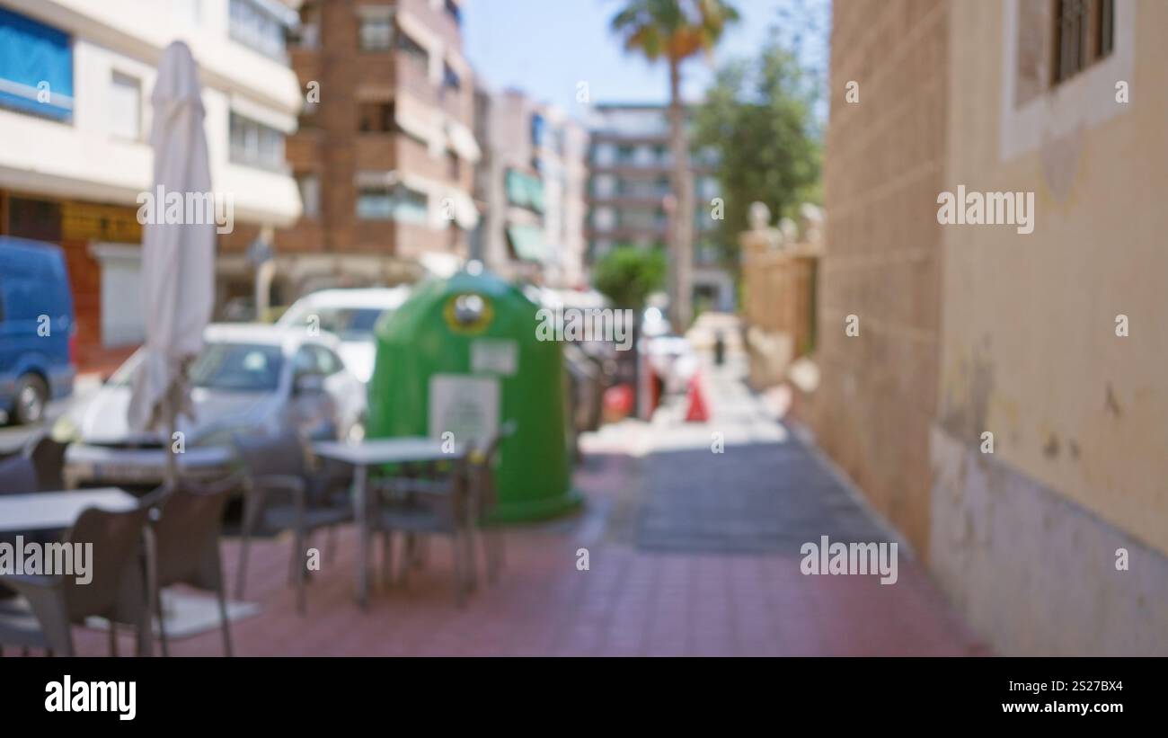 Outdoor street scene with blurred background showing tables, chairs ...