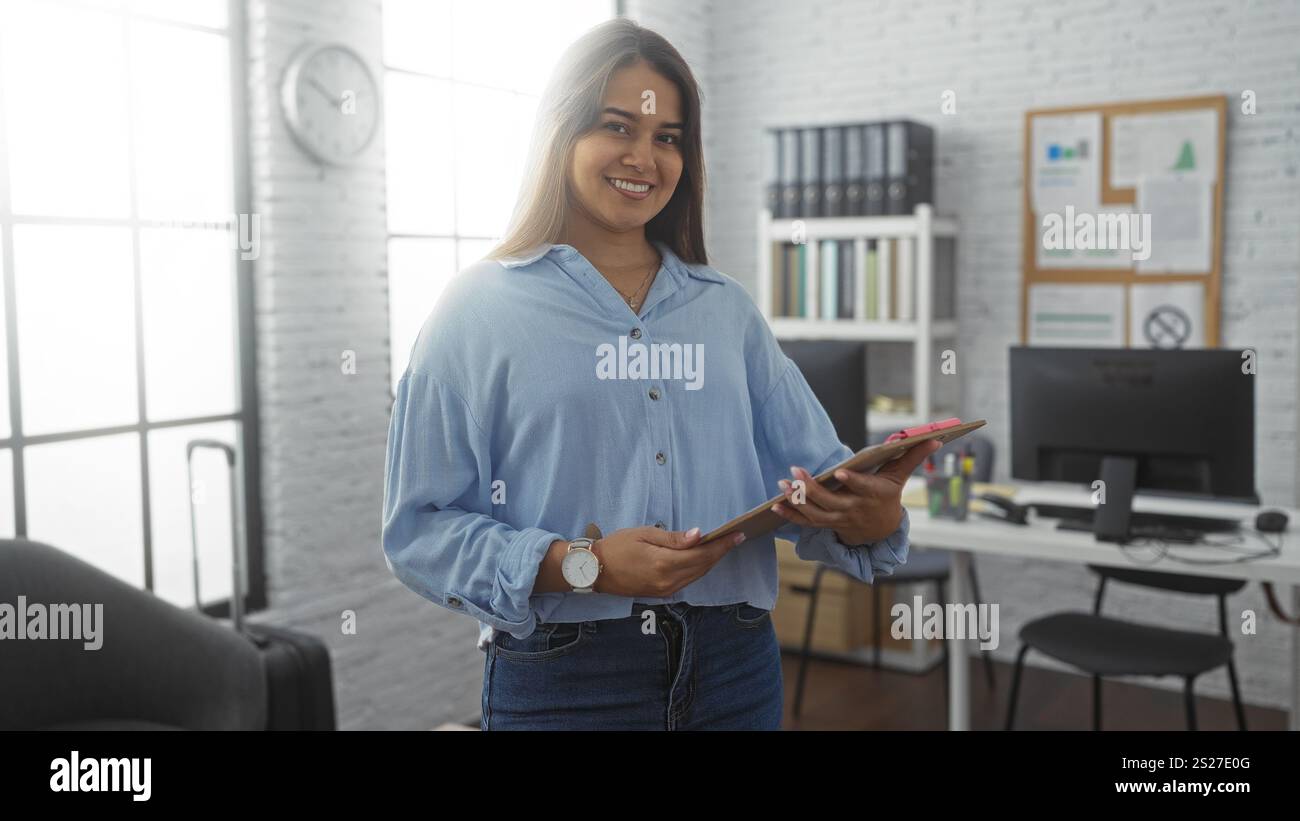 Young woman reading document in office setting with natural light and ...