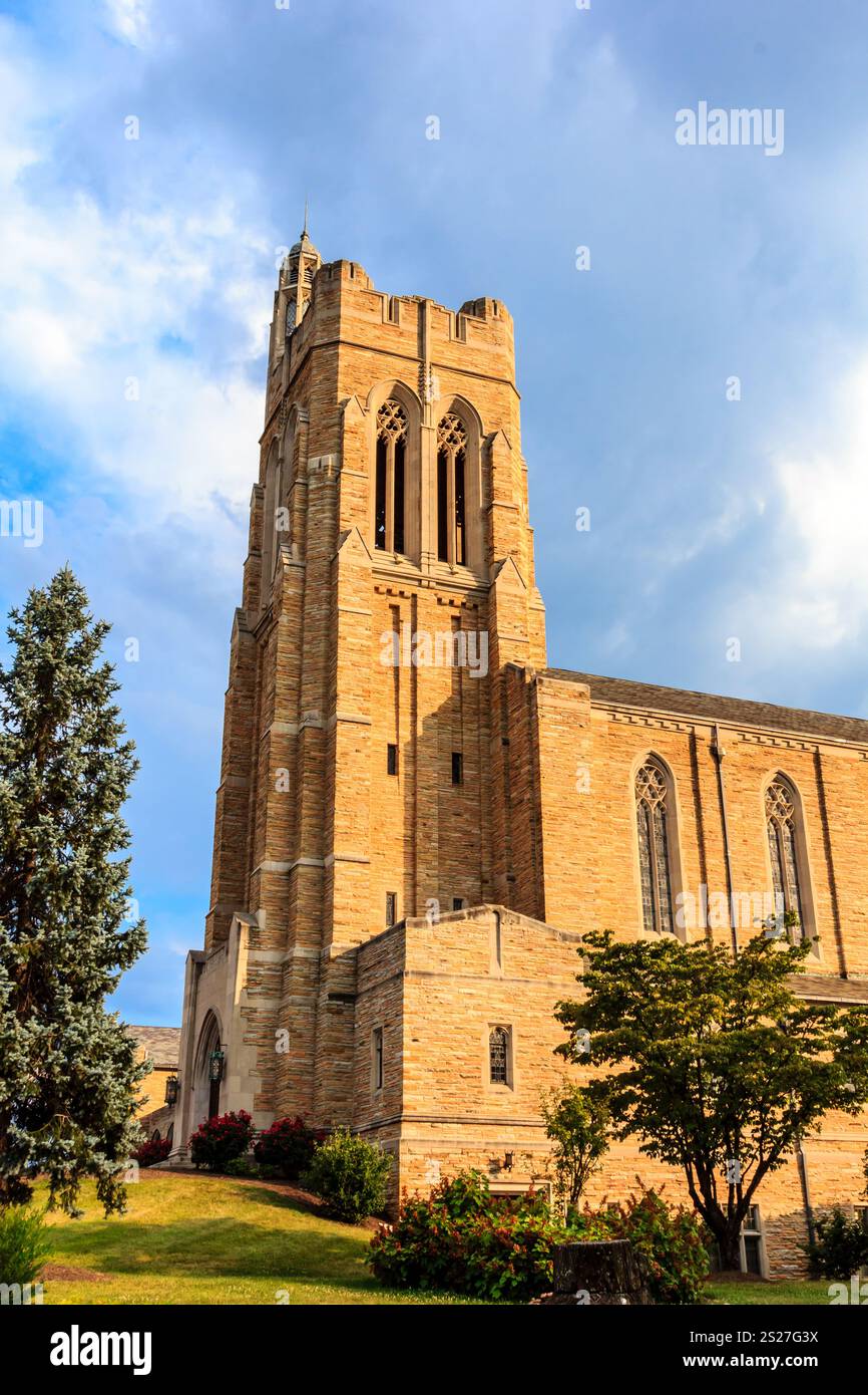 A large brick building with a steeple and a clock tower. The building ...