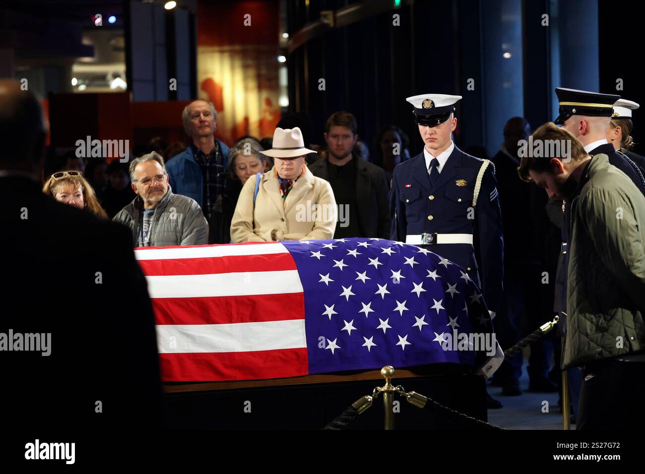 Mourners view the casket of former President Jimmy Carter as he lies in ...