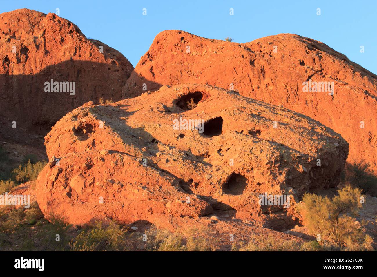 A large rock with a hole in the middle of it. The rock is surrounded by ...