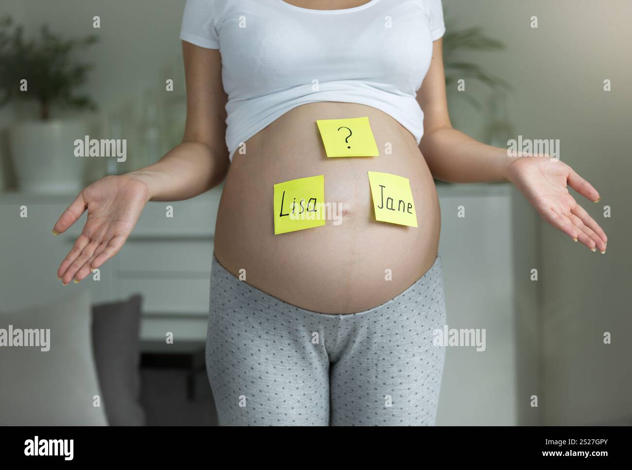 Concept of choosing baby's name.Young regnant woman with names written ...