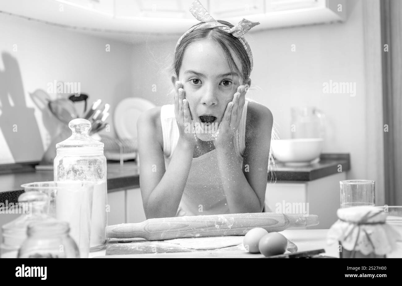 Black And White Portrait Of Excited Girl Clapping On Her Cheeks With