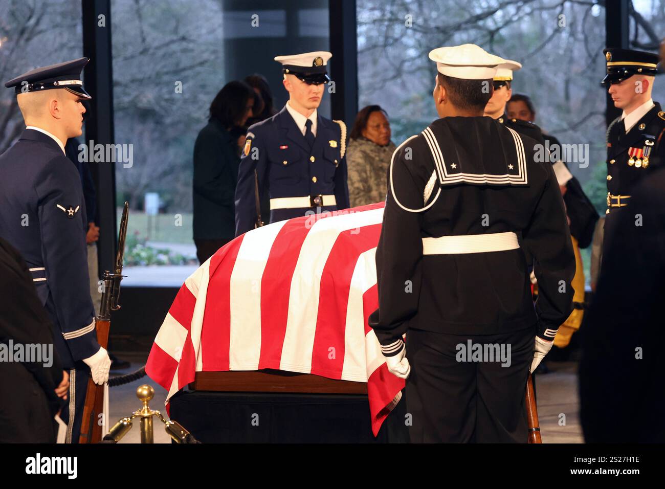 Mourners view the casket of former President Jimmy Carter as he lies in ...