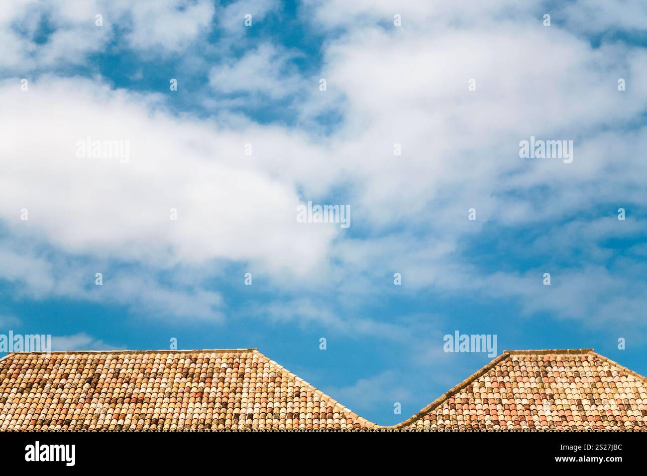 Travel to Algarve Portugal - white clouds in blue sky over orange tile ...