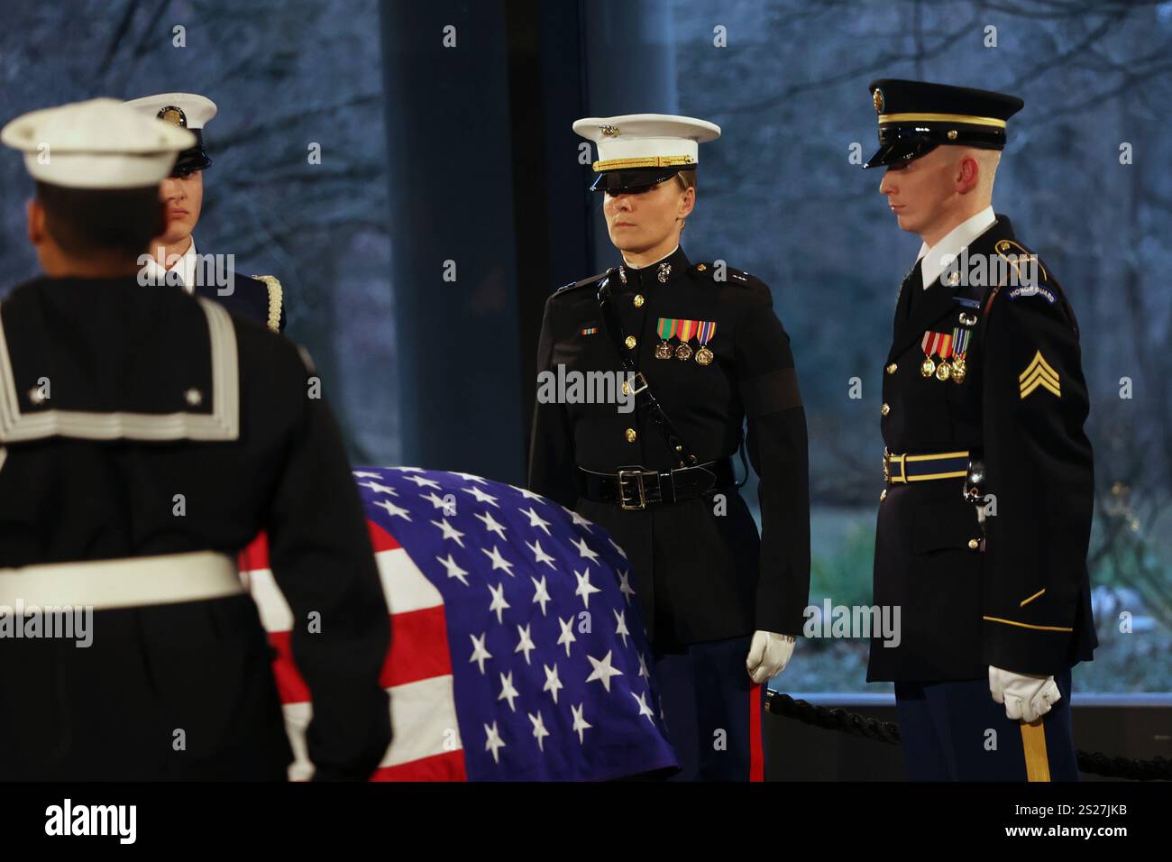 A military honor guard changes positions at the casket of former President Jimmy Carter as he ...