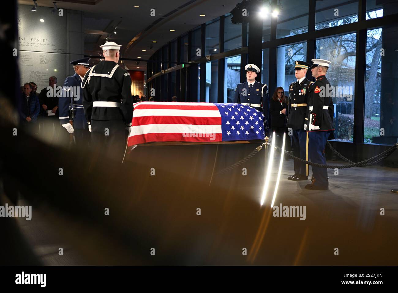 Military honor guard change positions at the casket of former President Jimmy Carter as he lies ...