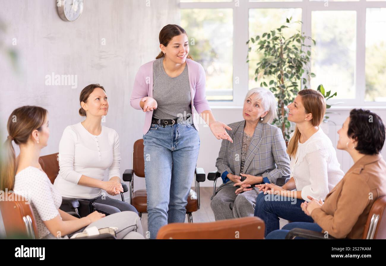 Woman tells an interesting story. Female students listening carefully ...
