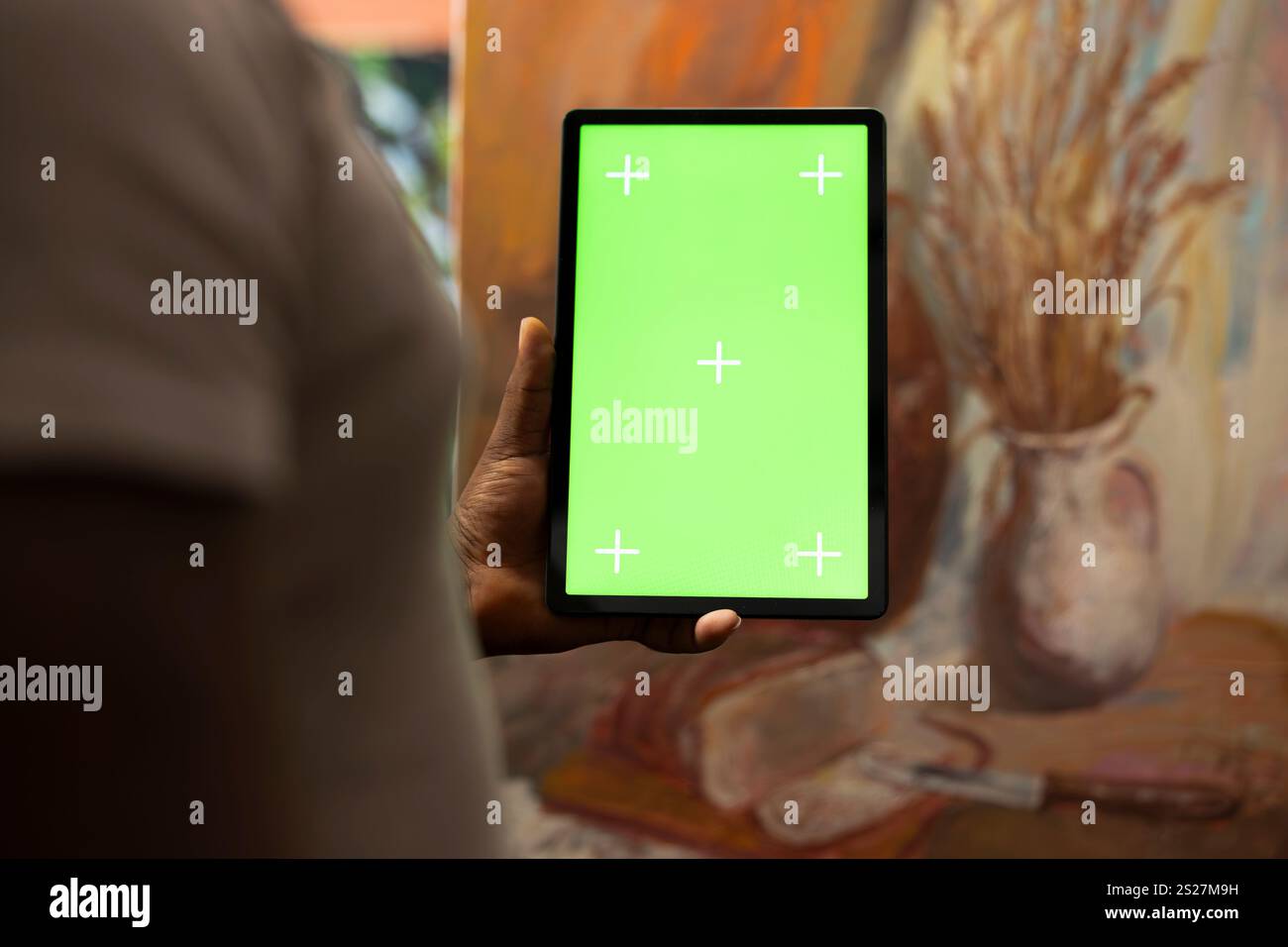 African american artist holding device with green screen mockup in art ...