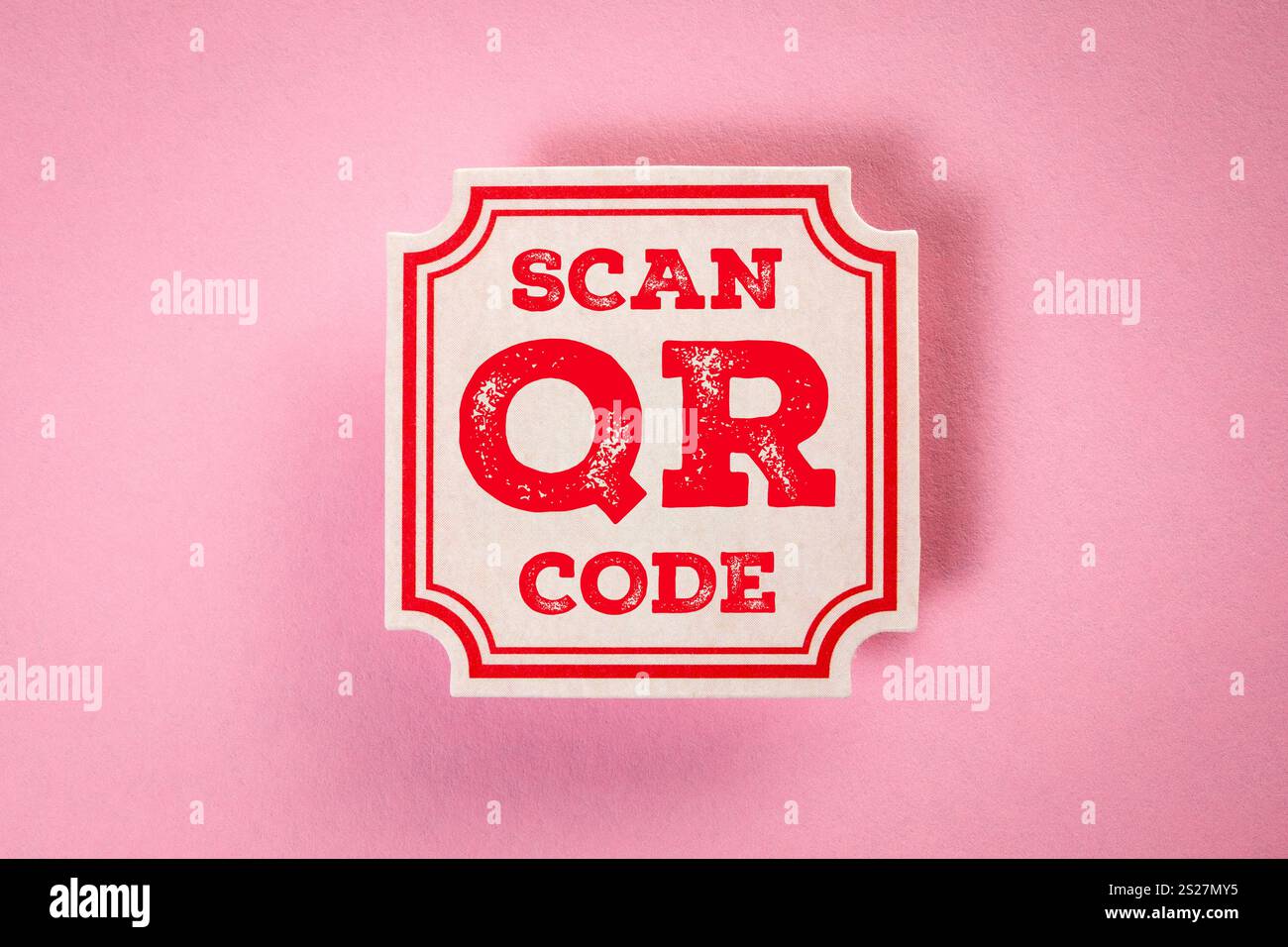 Scan QR code. Cardboard sheet with text on a pink background Stock ...
