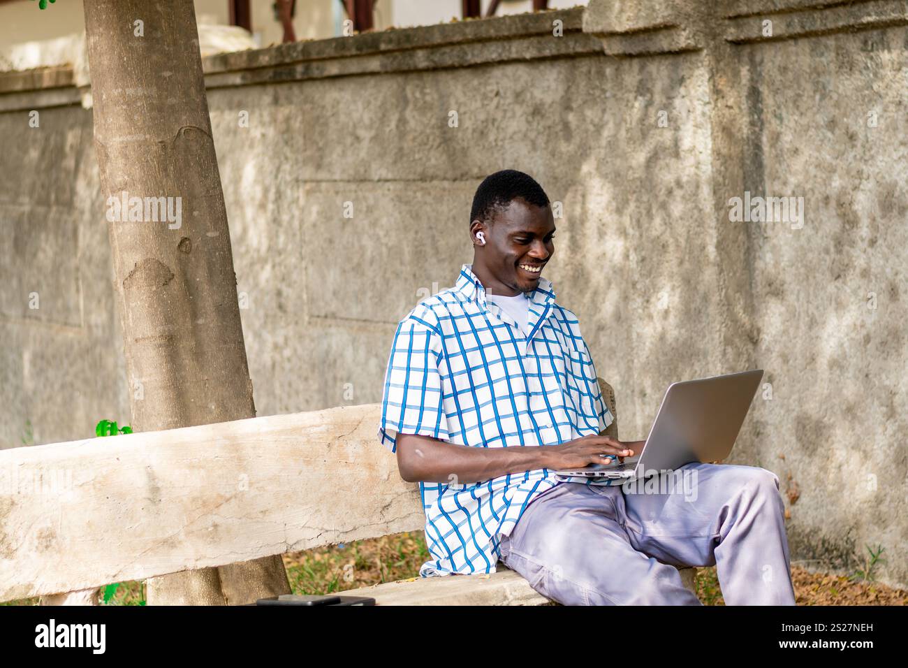 image of Excited young African American man making use on laptop ...