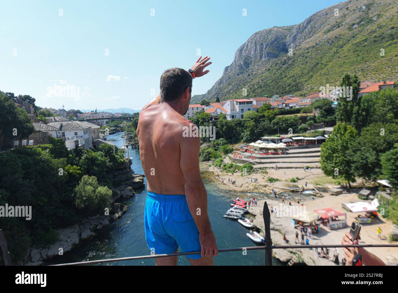 Daredevil diver jumping off the Stari Most (Old Bridge). Mostar. Bosnia ...