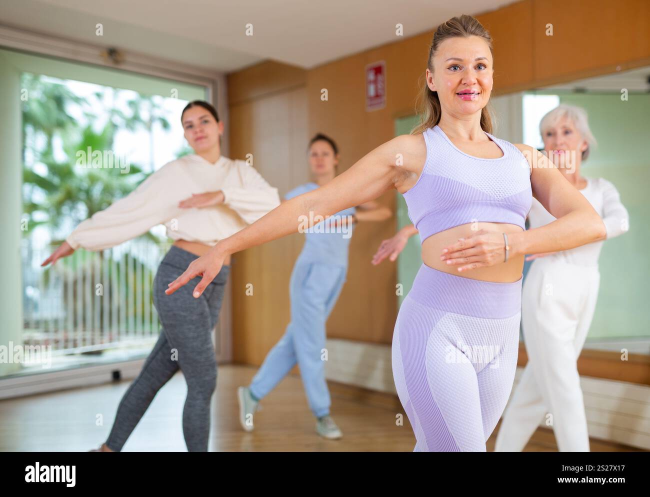 Group are practising arch movement in step jazz dance in fitness gym ...