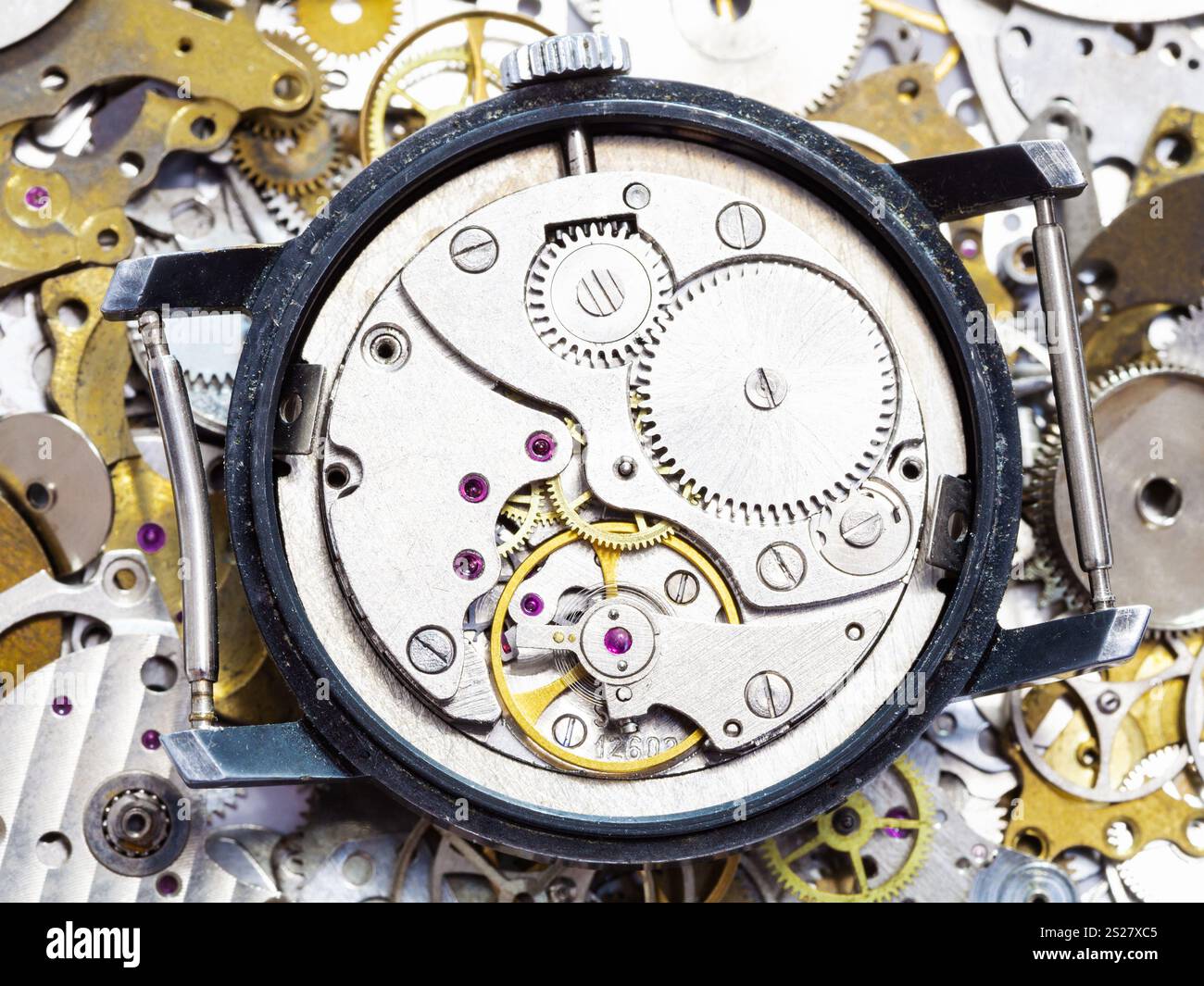 watchmaker workshop - open old mechanical wristwatch on pile of clock ...