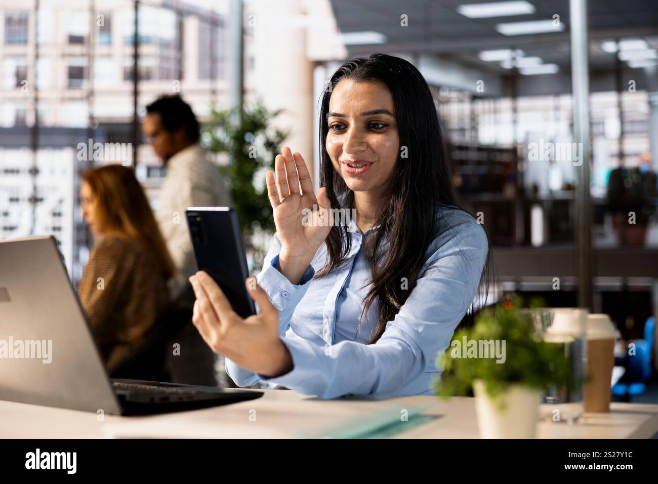 Professional indian worker leads a teleconference with team members ...