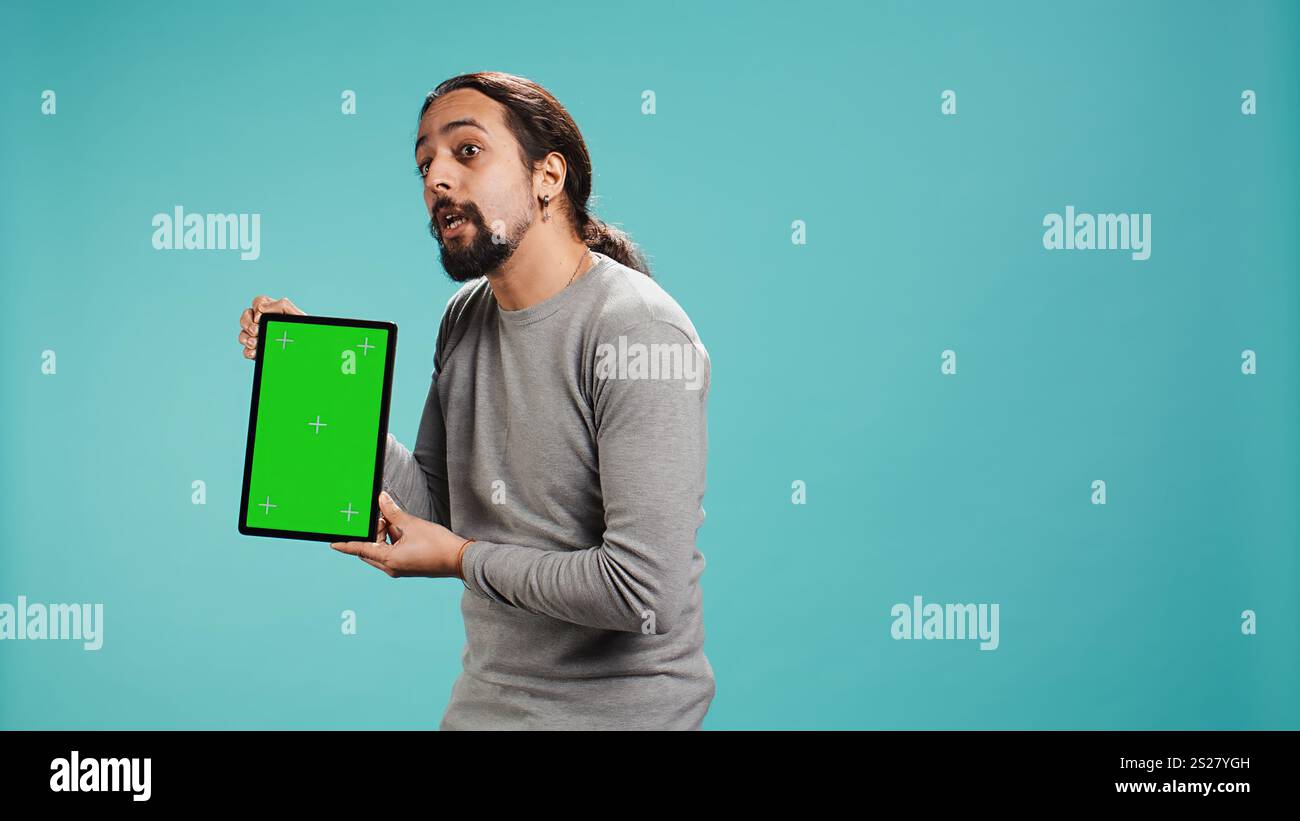 Happy man holding green screen tablet, doing recommendation. Cheerful ...