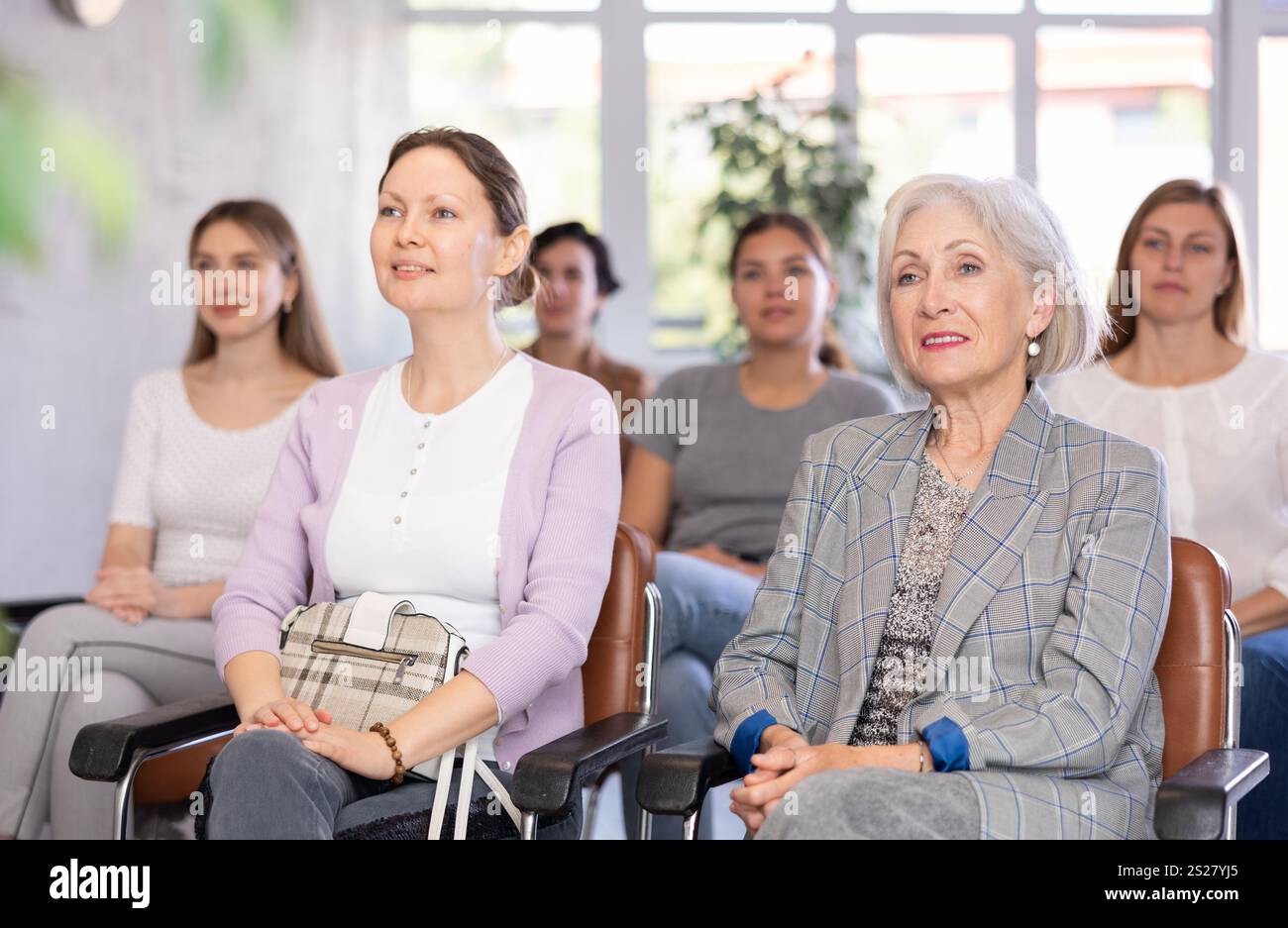 In audience, students sit staring at teacher and listen to lecture ...