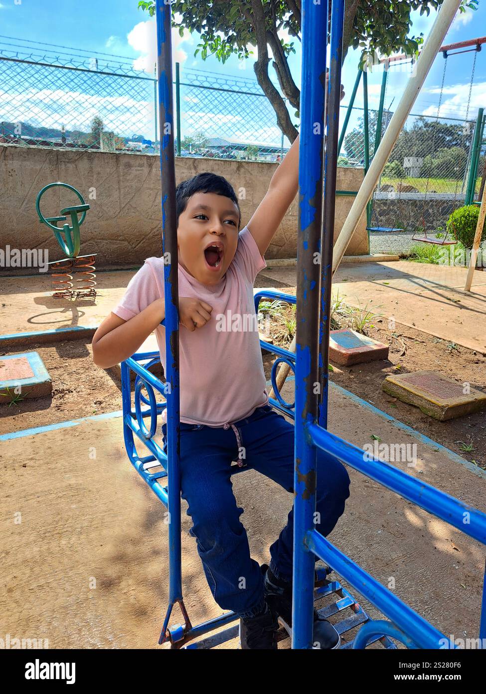9-year-old dark-skinned Latino male child practices balance exercises ...