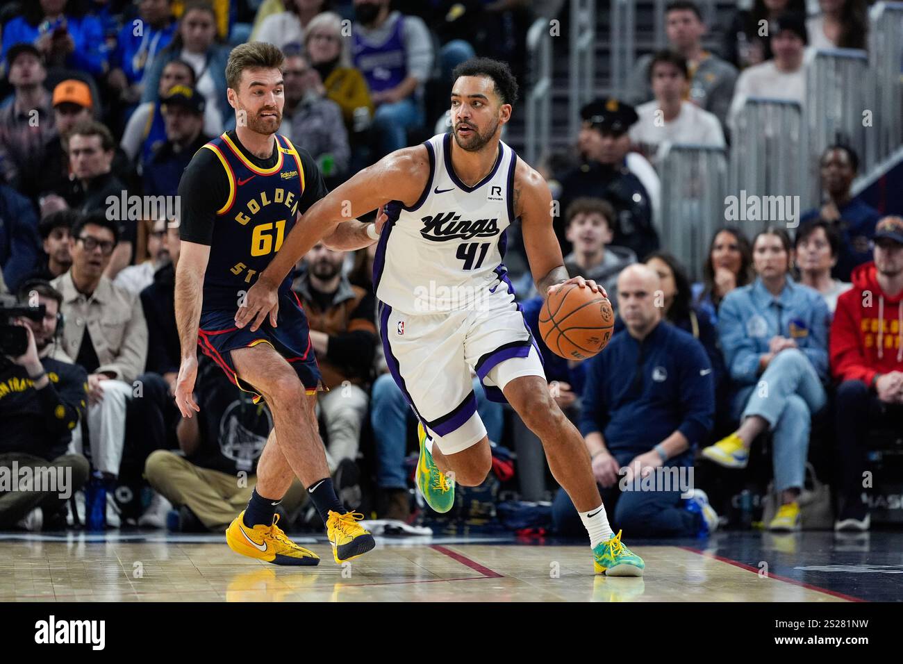 Sacramento Kings forward Trey Lyles, right, moves the ball while ...
