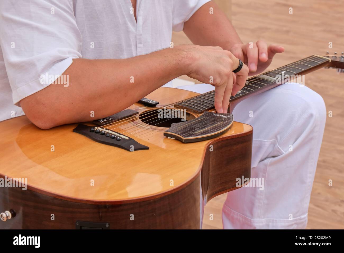 Close-up on hands of guitarist playing classical guitar in two handed ...