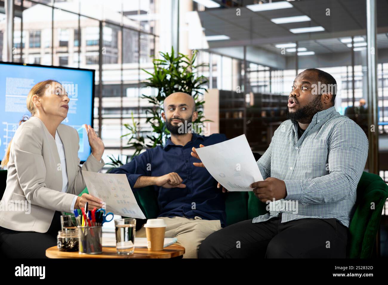 Upset diverse team of employees arguing after making mistake while ...