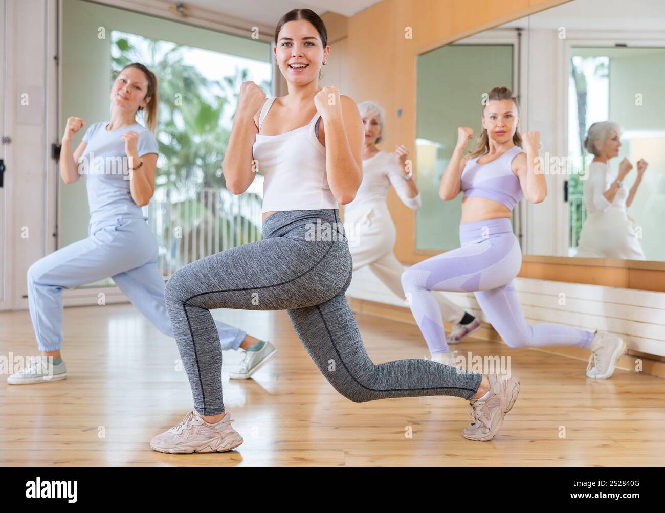 Active young woman practicing aerobic dance in training hall Stock ...