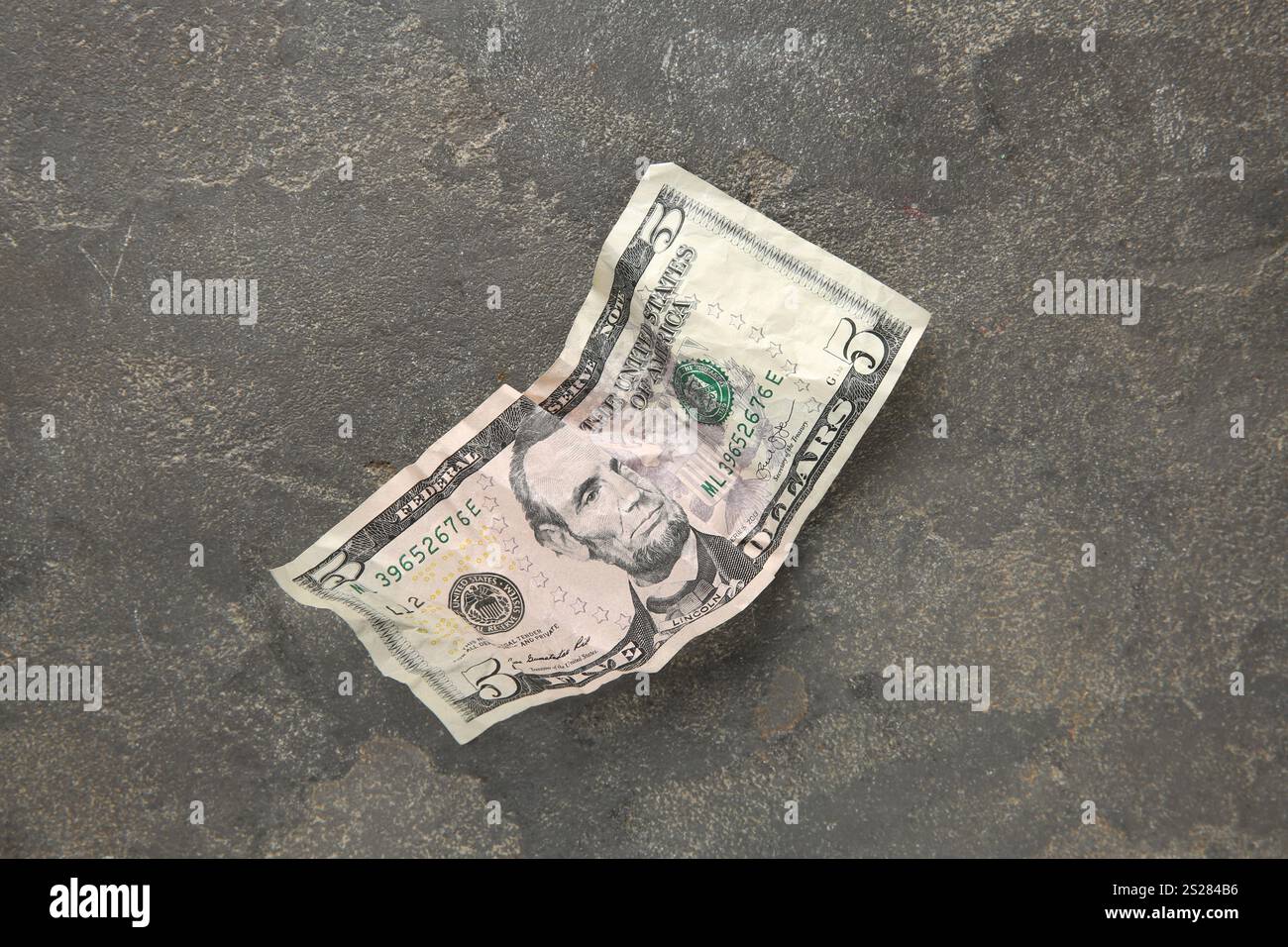 One crumpled dollar banknote on grey table, top view Stock Photo - Alamy