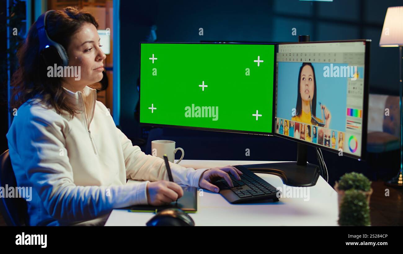 Photo editor using green screen monitor to color correct photographs in ...