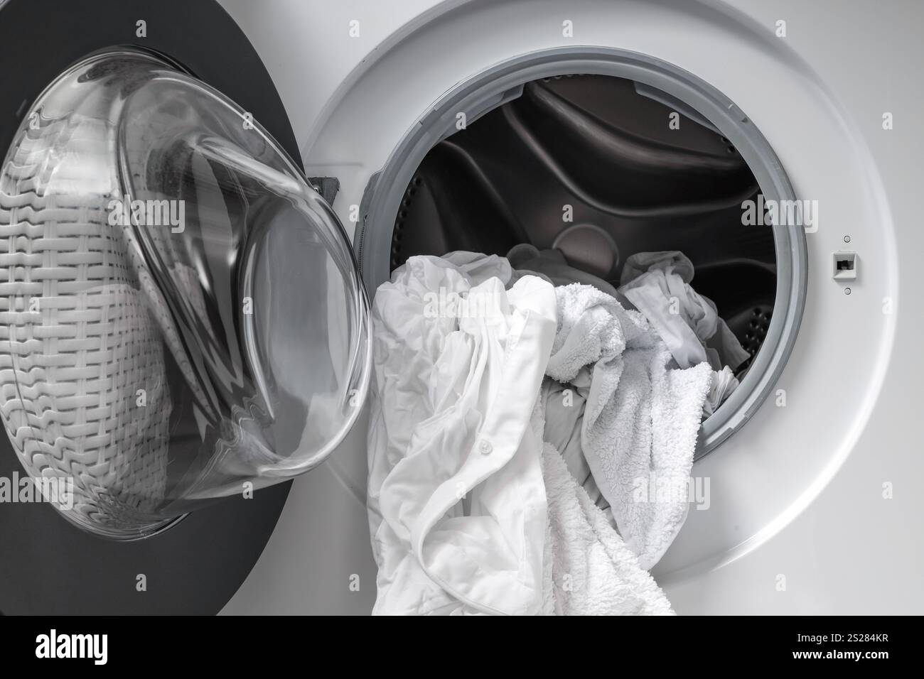 Open washing machine with clean clothes, closeup Stock Photo - Alamy