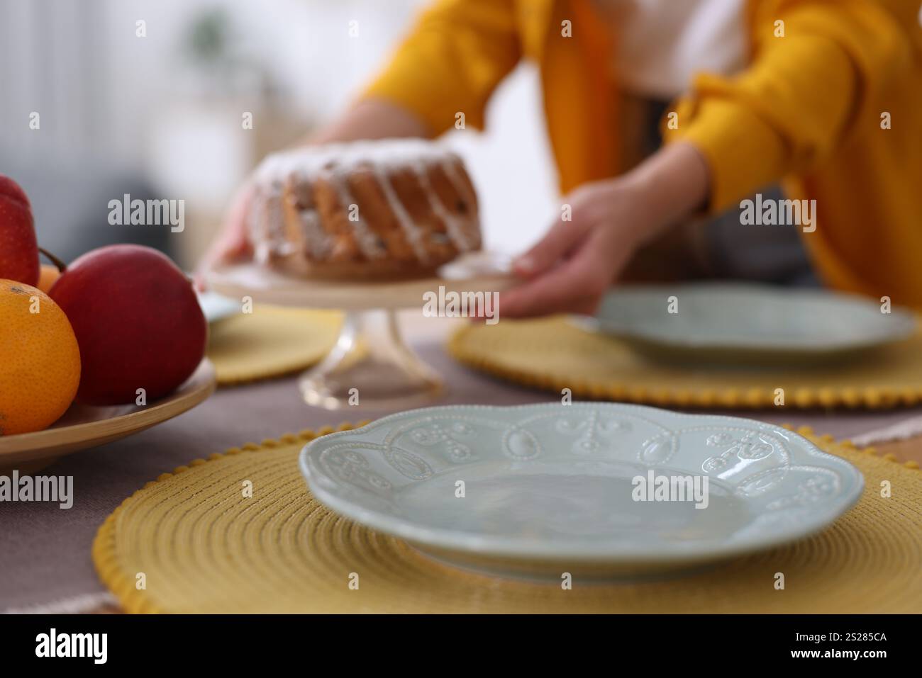 Woman setting table for dinner at home, closeup Stock Photo - Alamy