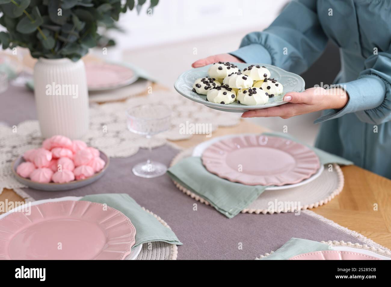 Woman setting table for dinner at home, closeup Stock Photo - Alamy