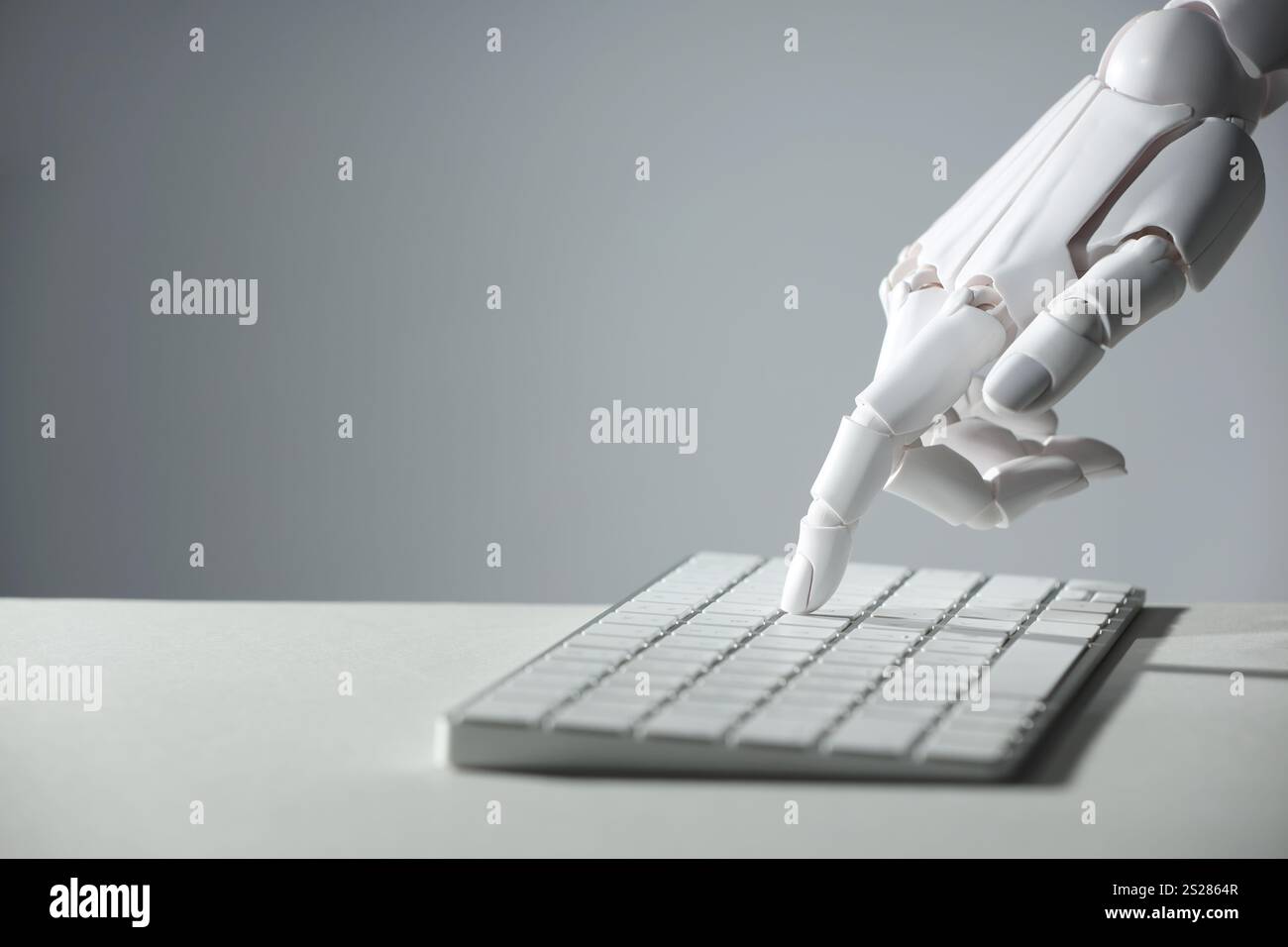 Artificial intelligence. Robot hand using keyboard at light table ...
