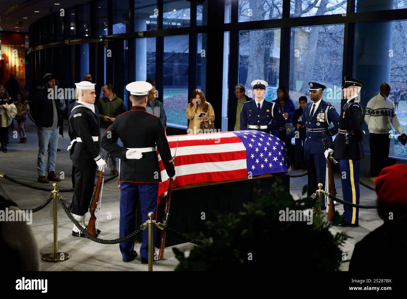 Members of the joint services military honor guard stand by the casket bearing the remains of ...
