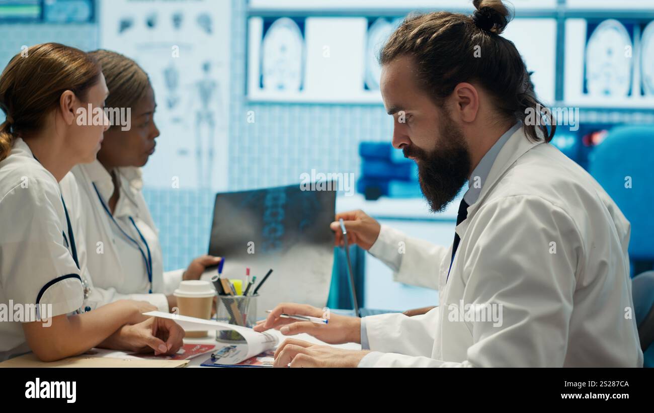 Medical professionals analyzing anatomy x ray scans to find the best ...