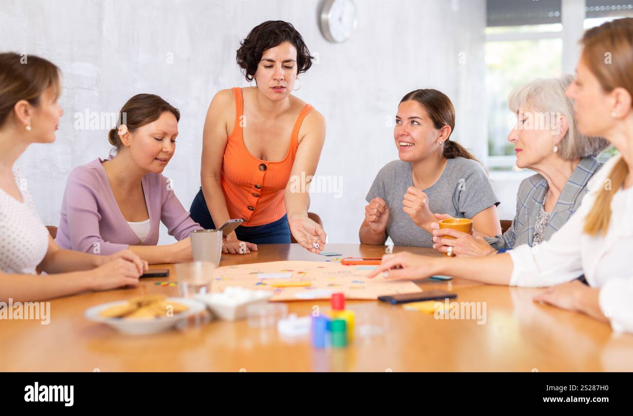 Group of students of different years play board game with passion Stock ...
