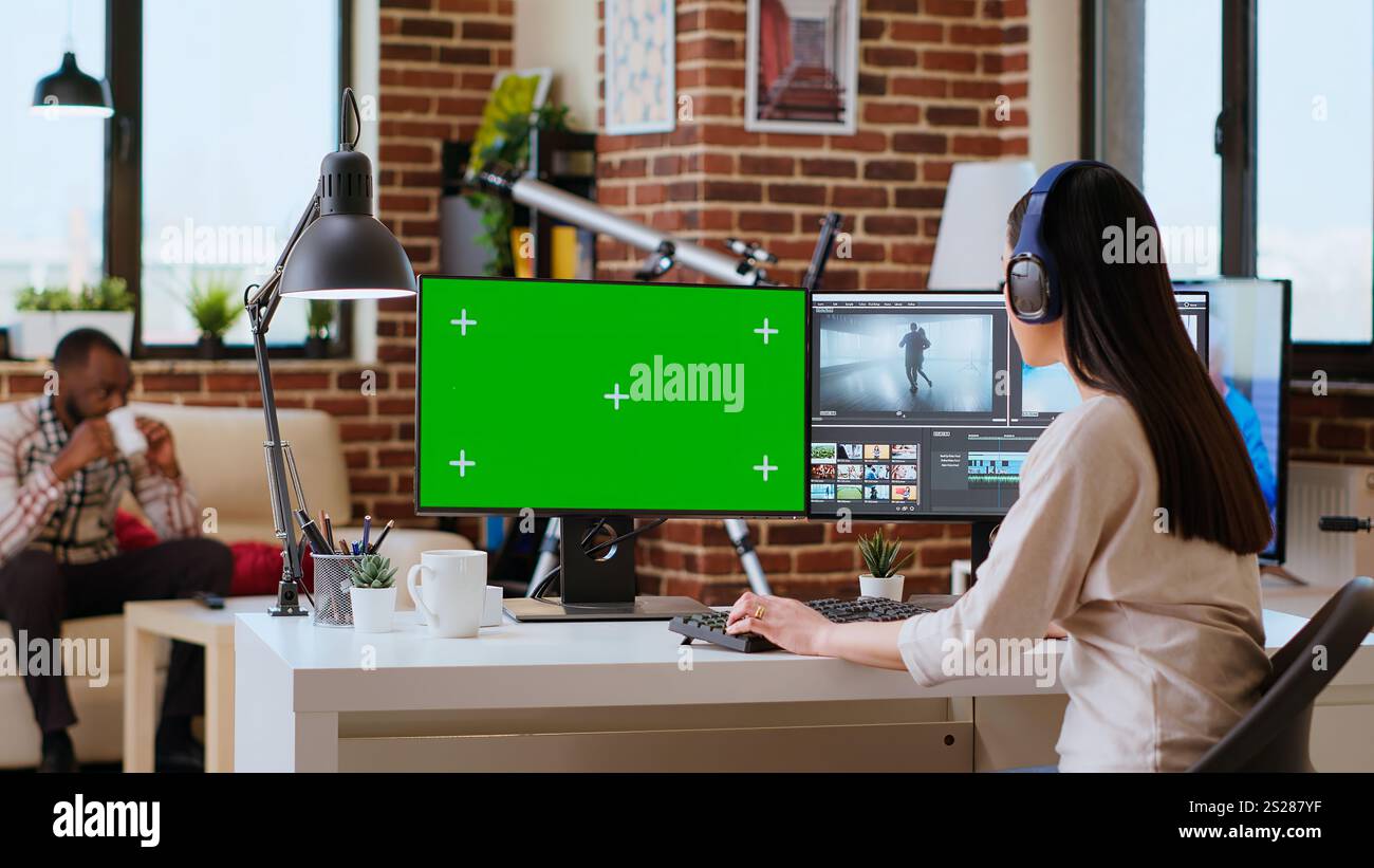 Female video editor working on a creative project video shoot, using ...