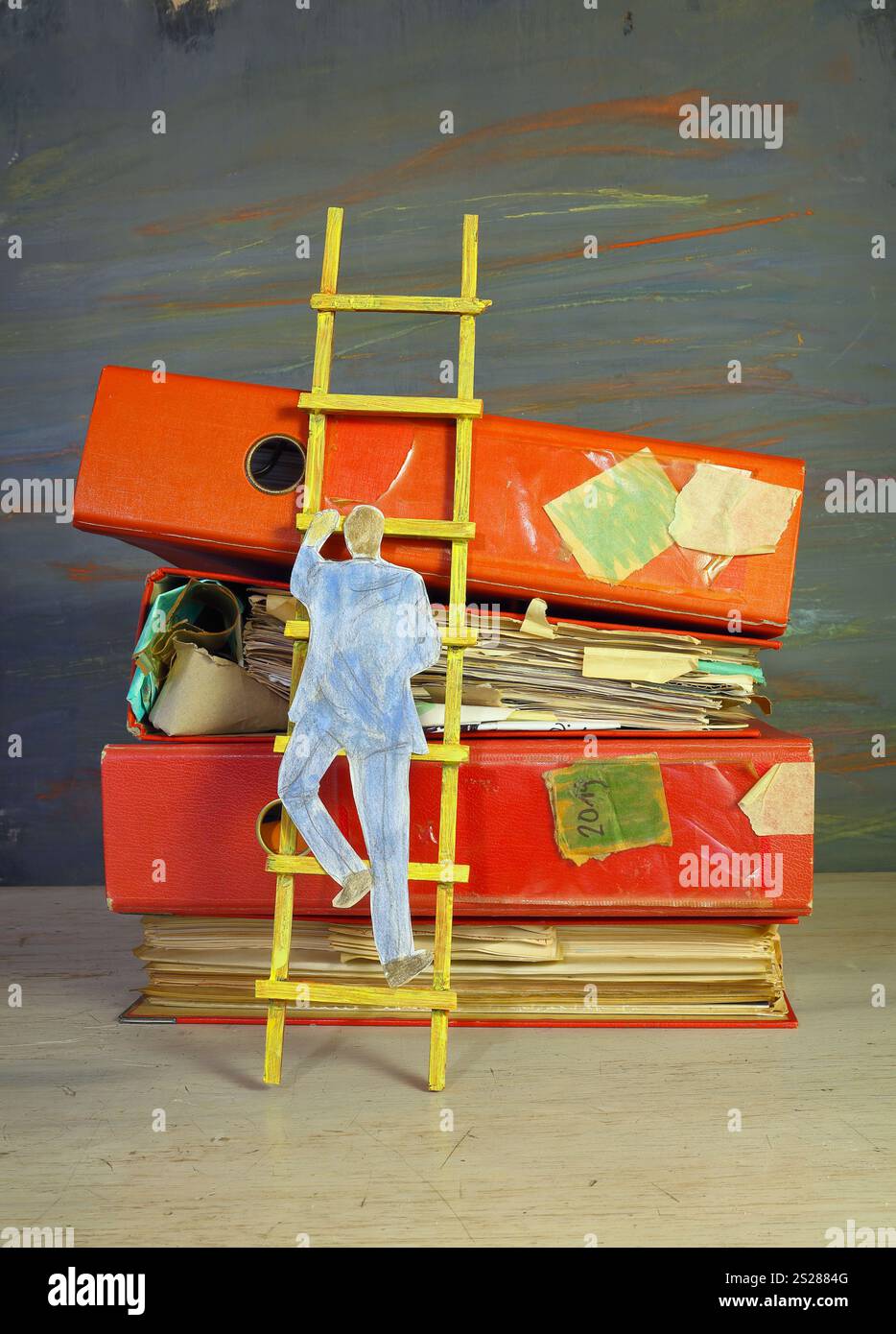 stack of messy file folders, blurred bookshelf in the back,red tape ...