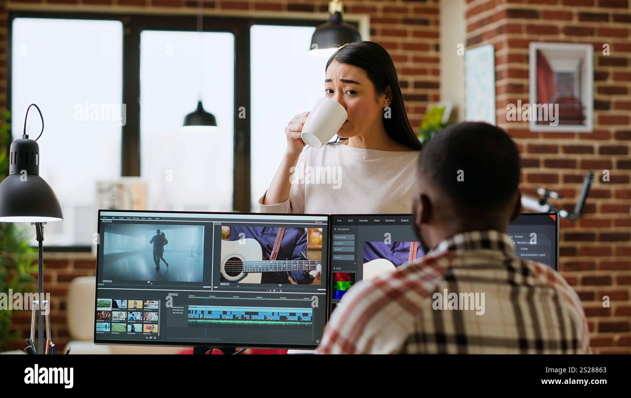 Creative team interracial partners collaborating on a video editing project, using high end ...