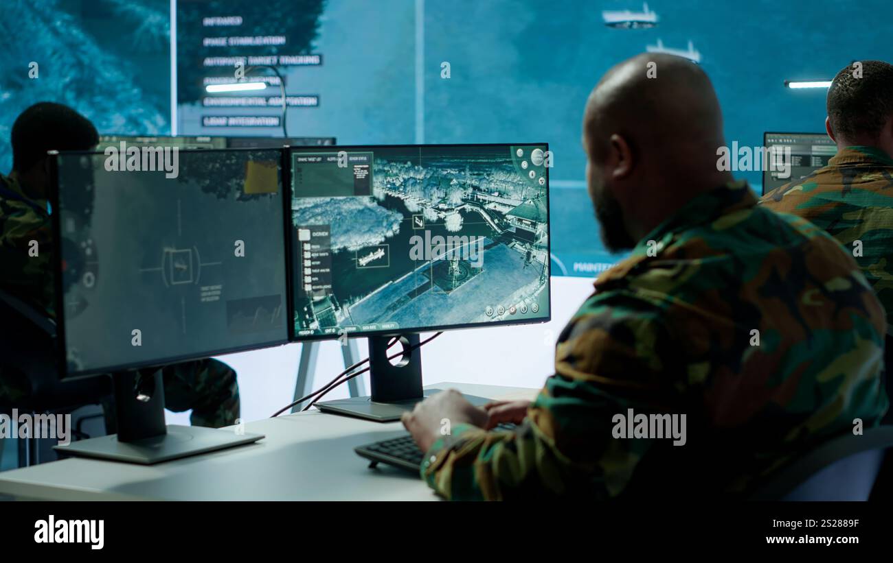 Military crew in a high tech operations command post managing ...