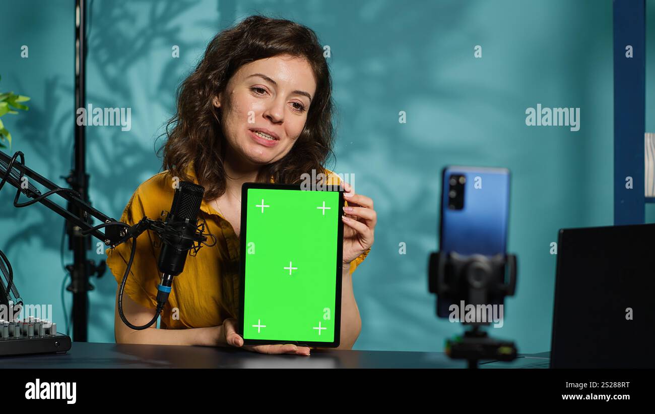 Happy technology expert at home holding newly launched green screen ...