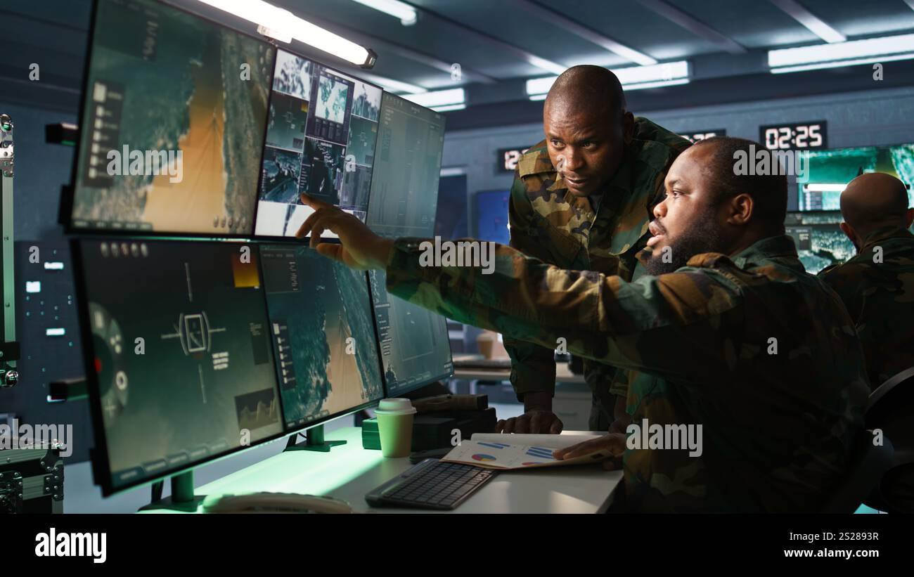 Air force officer and colleague performing tactical level surveillance ...